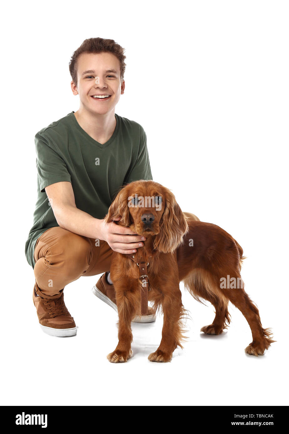 Teenage boy with cute dog on white background Stock Photo - Alamy