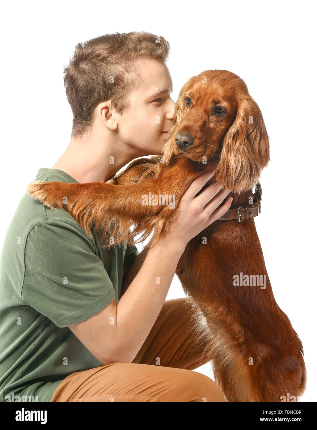 Teenage boy with cute dog on white background Stock Photo - Alamy