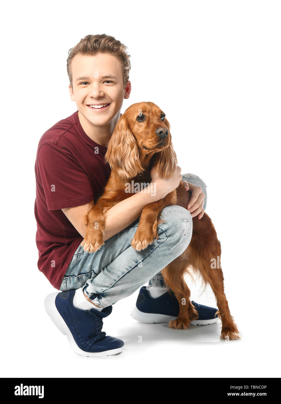 Teenage boy with cute dog on white background Stock Photo - Alamy