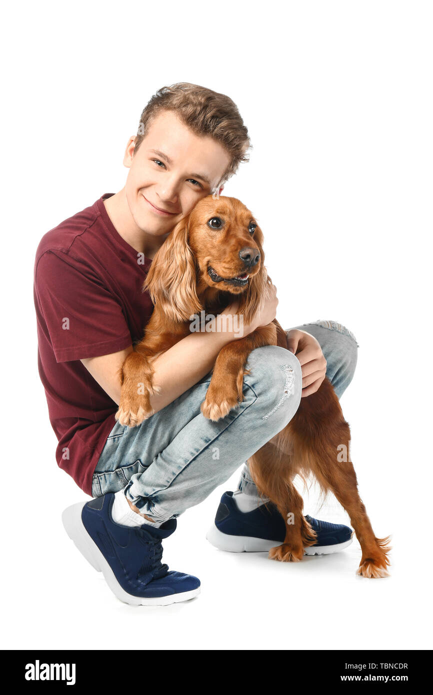 Teenage boy with cute dog on white background Stock Photo - Alamy