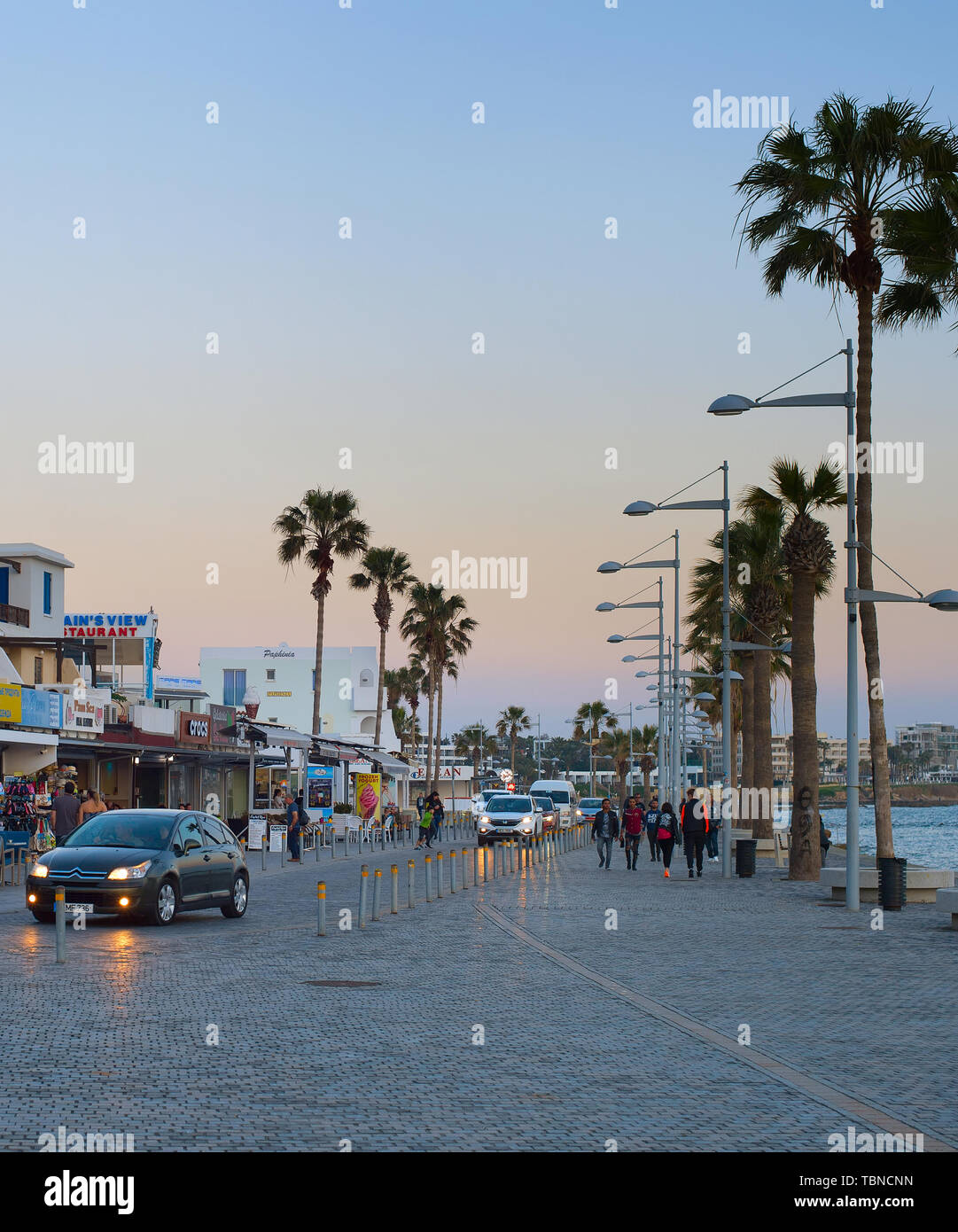 PAPHOS, CYRPUS - FEBRUARY 13, 2019: People walking by Cyprus promenade ...