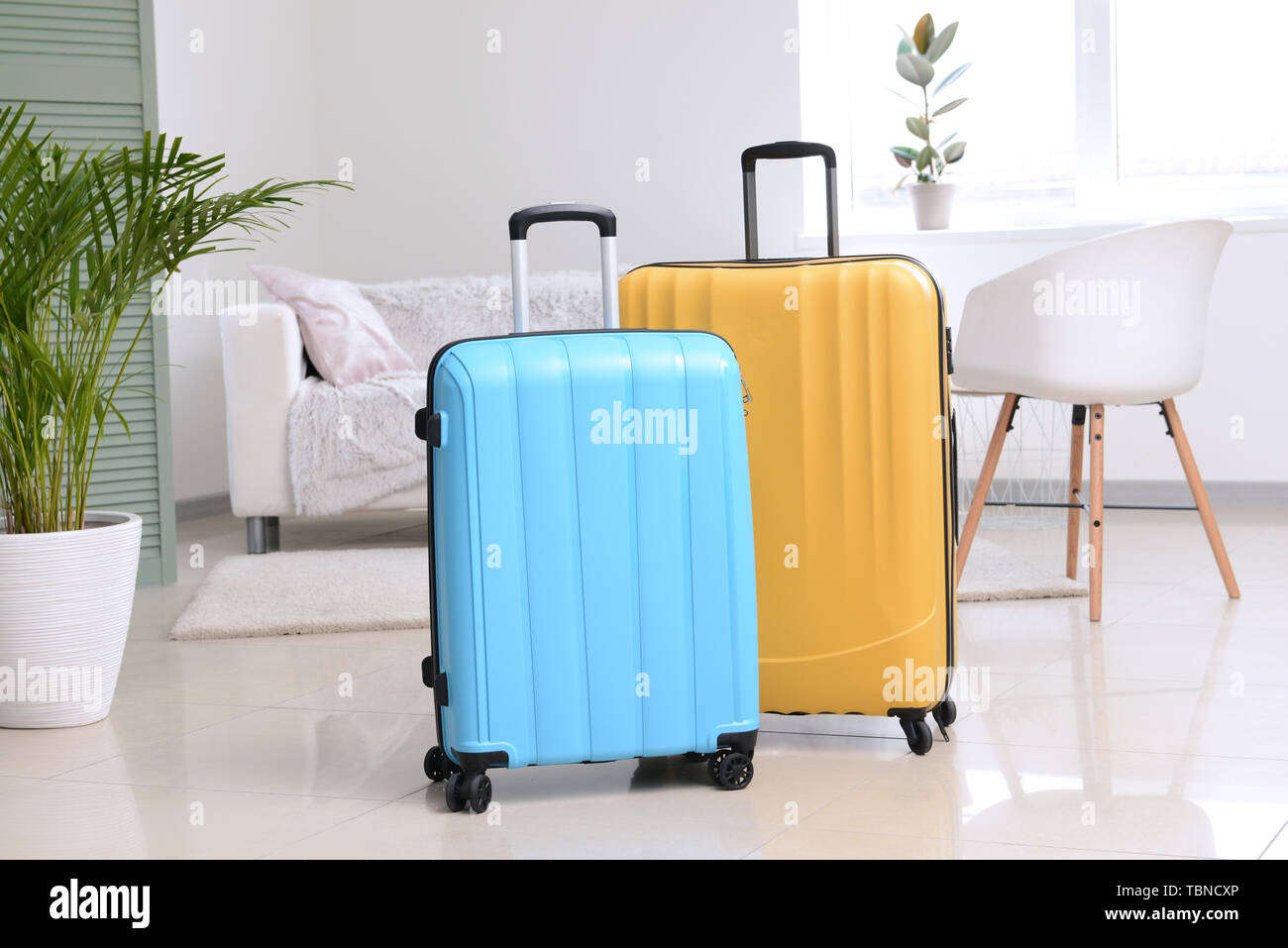 Packed suitcases in room Stock Photo - Alamy