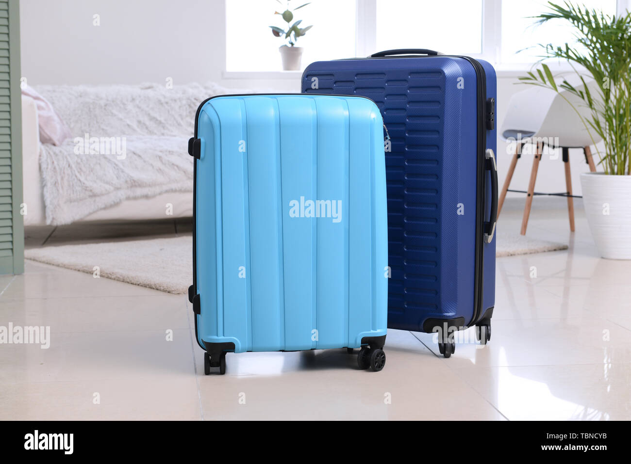 Packed suitcases in room Stock Photo - Alamy