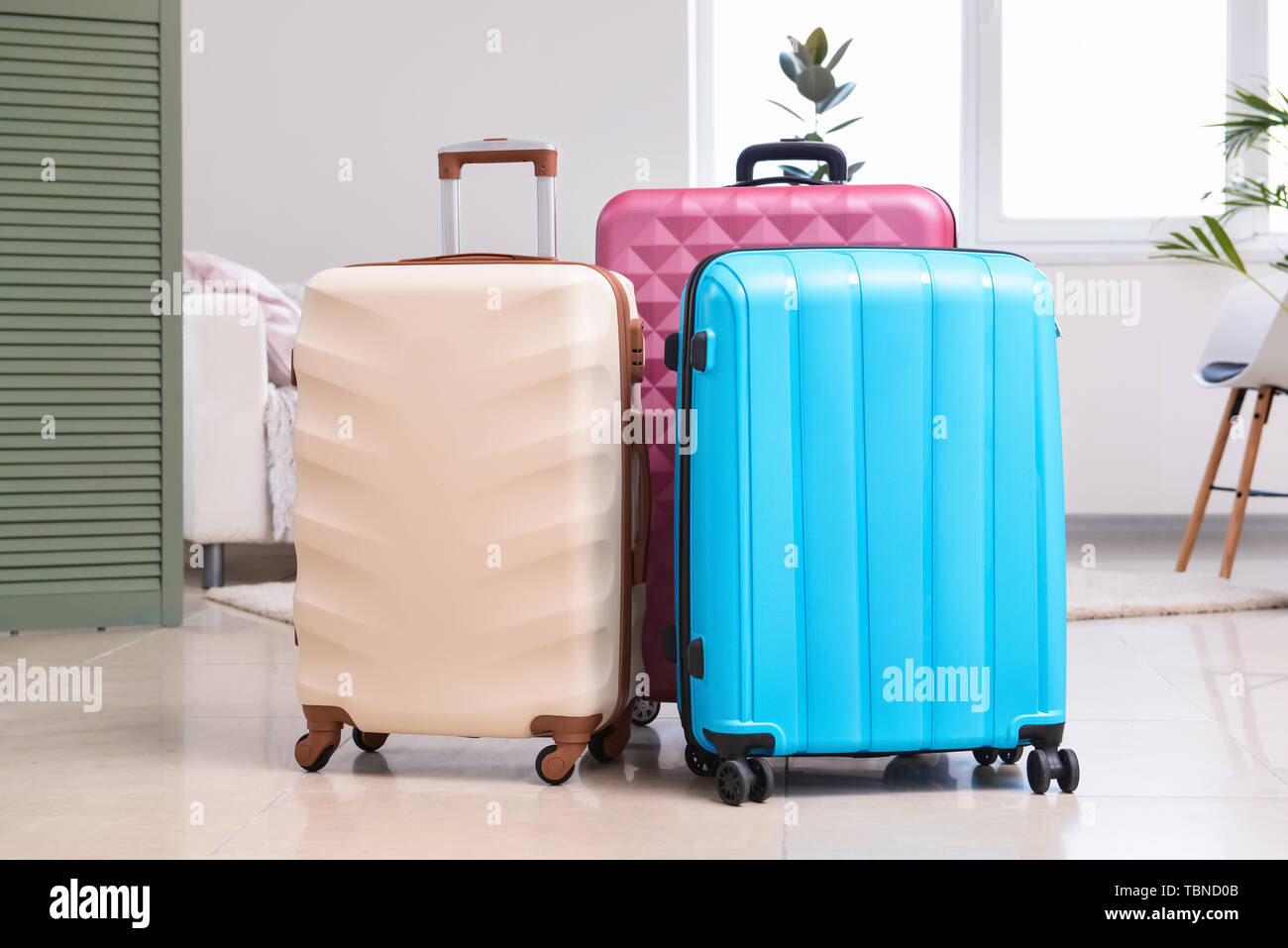 Packed suitcases in room Stock Photo - Alamy