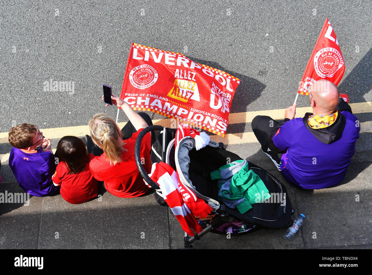 Fans line the street as they wait for the Liverpool team to arrive for ...