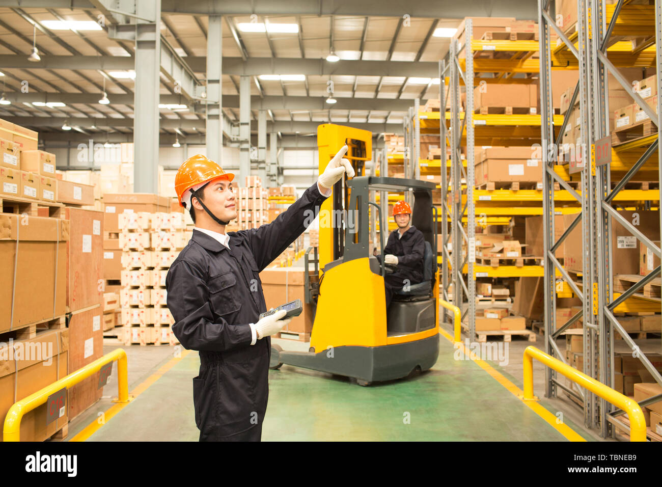 Logistics personnel load and unload cargo at the warehouse Stock Photo ...