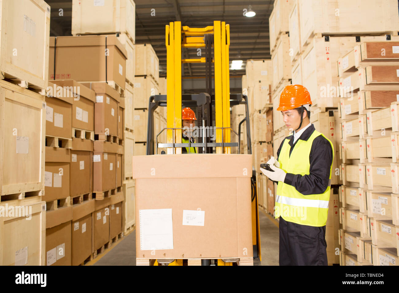 Logistics personnel load and unload cargo at the warehouse Stock Photo ...