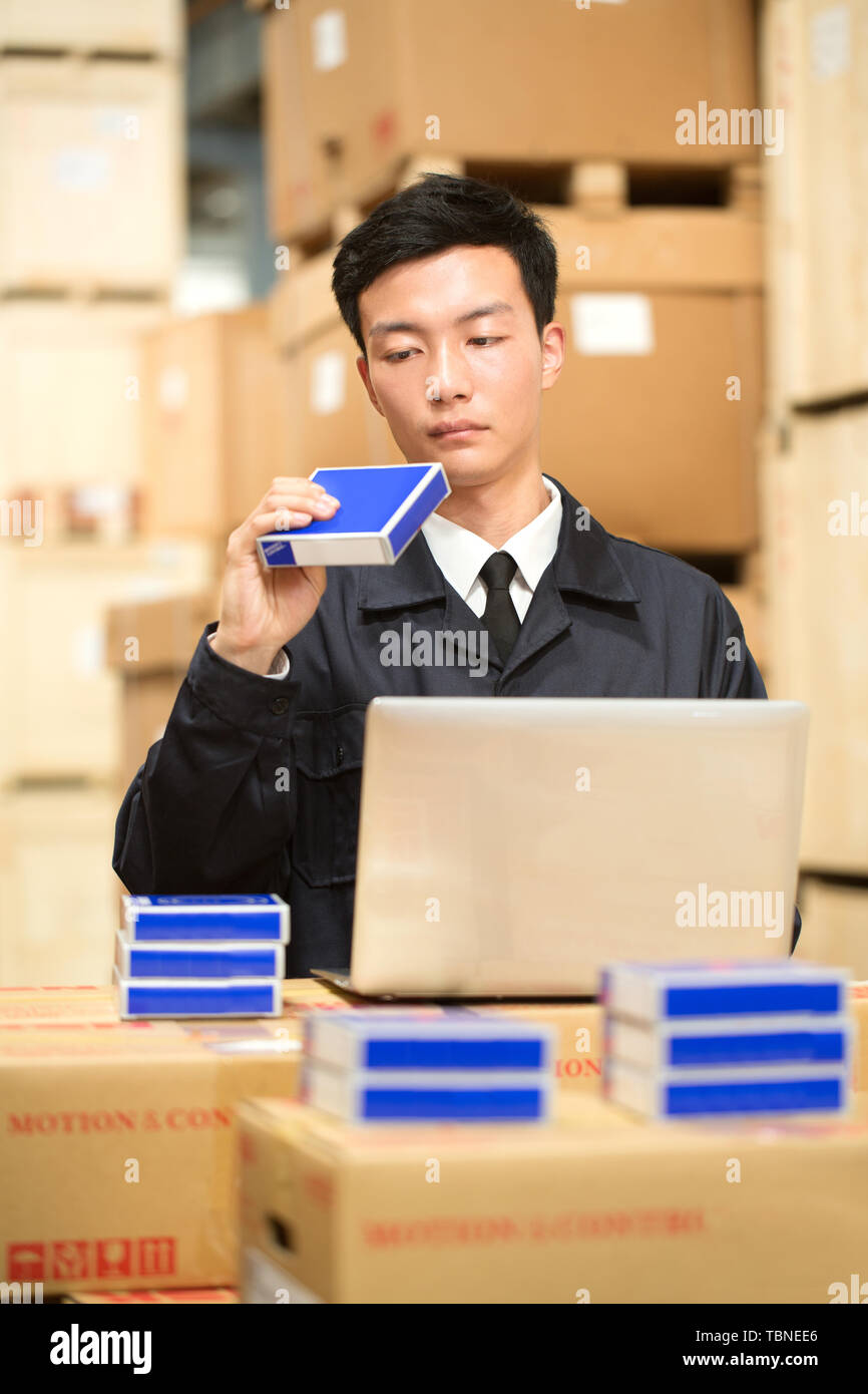 Logistics personnel load and unload cargo at the warehouse Stock Photo ...