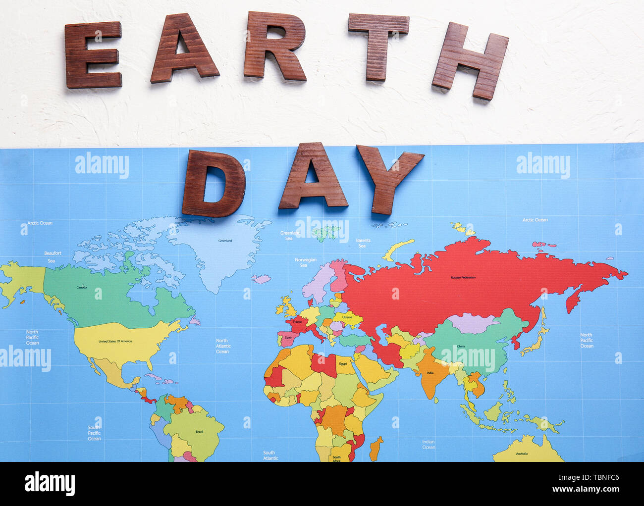 Text EARTH DAY with world map on white background Stock Photo - Alamy