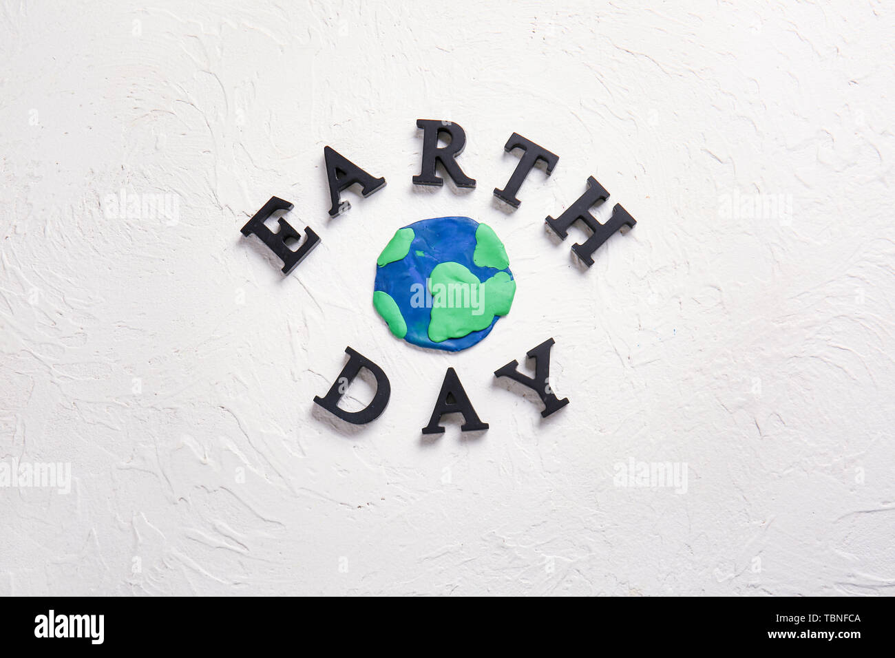 Text EARTH DAY composed from letters and shape of planet on white ...