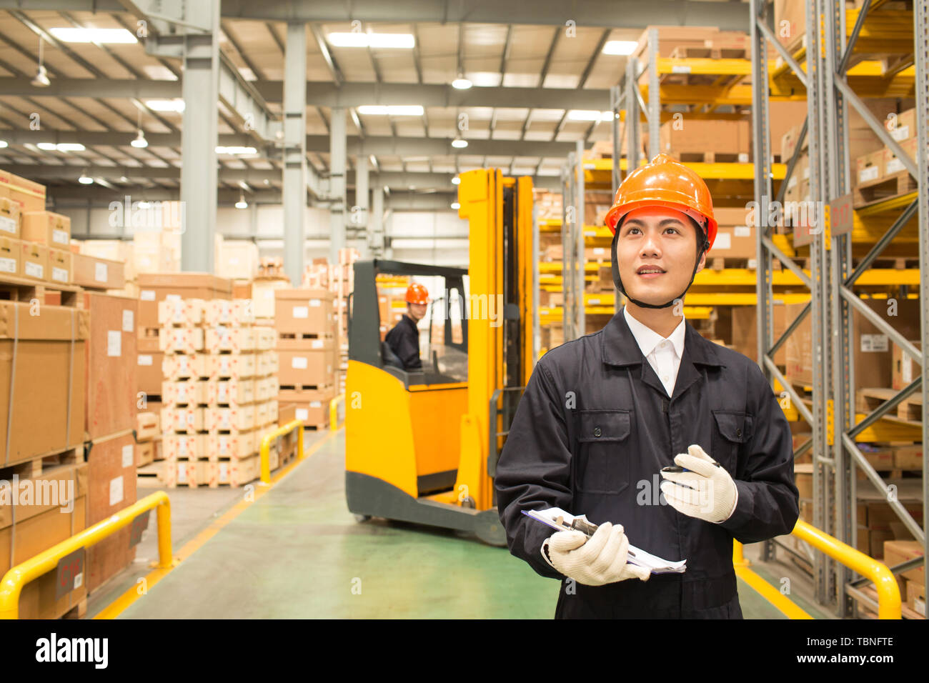 Logistics personnel load and unload cargo at the warehouse Stock Photo ...