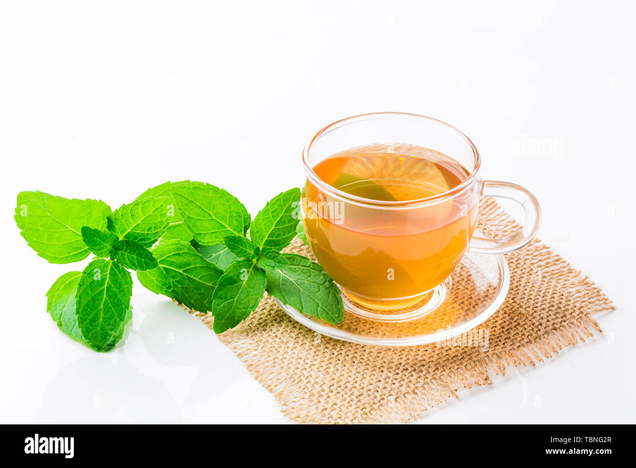 Peppermint tea and fresh peppermint leaves on white background Stock ...