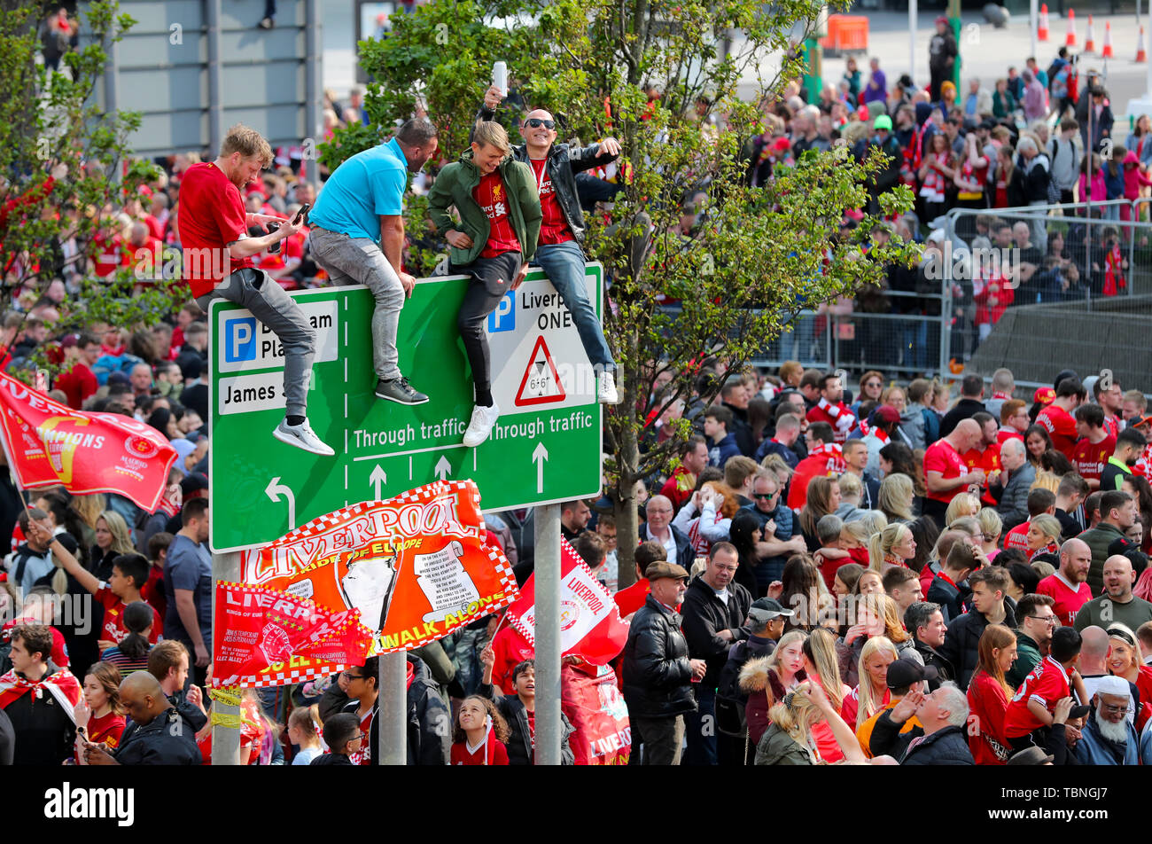 Liverpool fans on top of a road sign during the Champions League ...