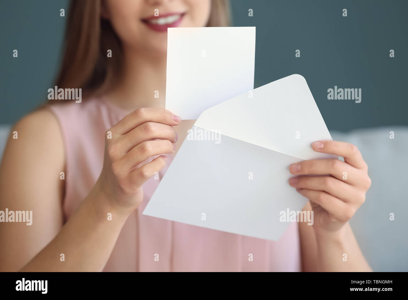 Young woman opening envelope with invitation at home, closeup Stock ...