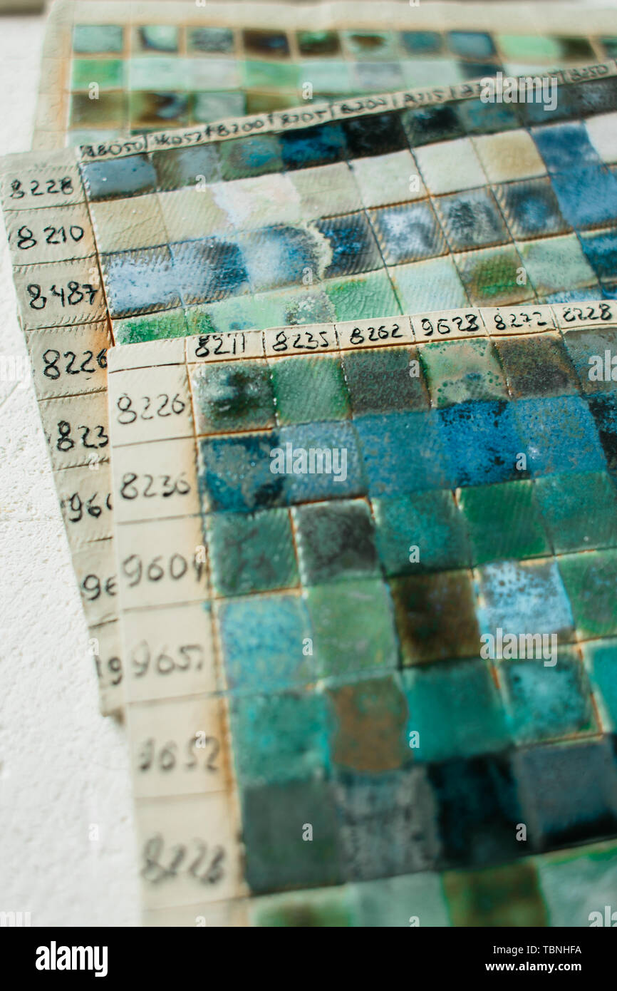 Potter holds the color palette glazes for coating ceramic products on ...