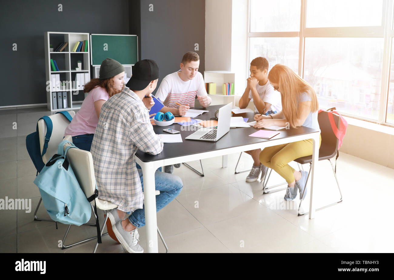 Group of teenagers studying together in school Stock Photo - Alamy