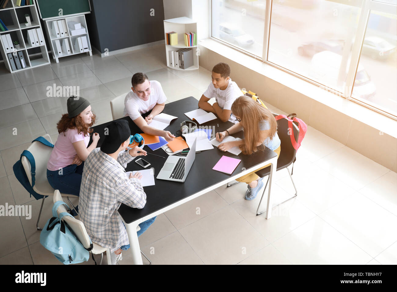 Group of teenagers studying together in school Stock Photo - Alamy