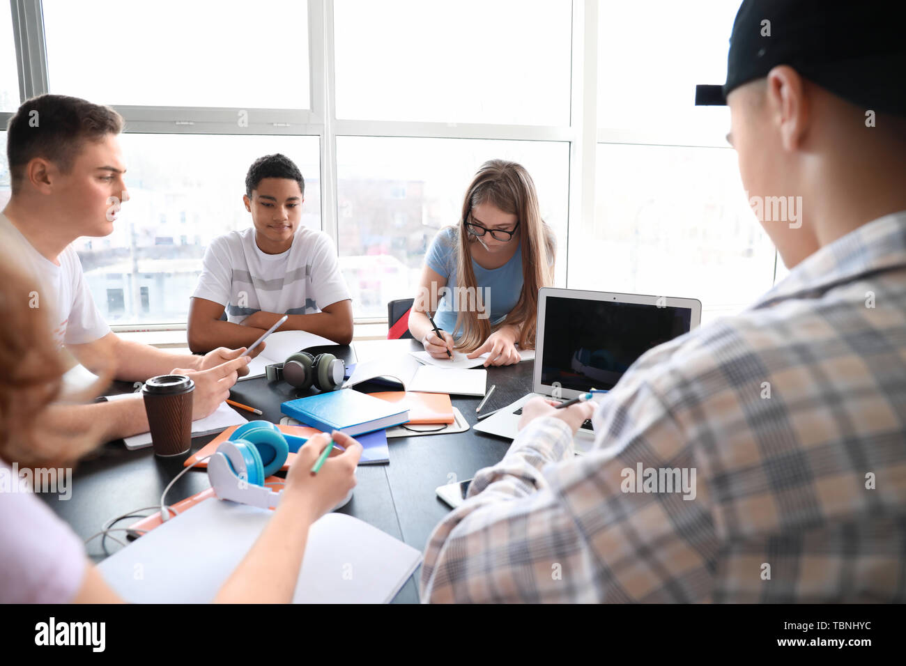 Group of teenagers studying together in school Stock Photo - Alamy
