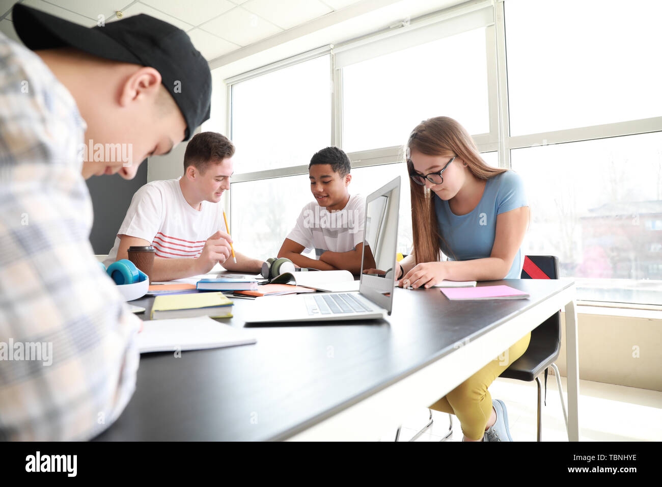 Group of teenagers studying together in school Stock Photo - Alamy