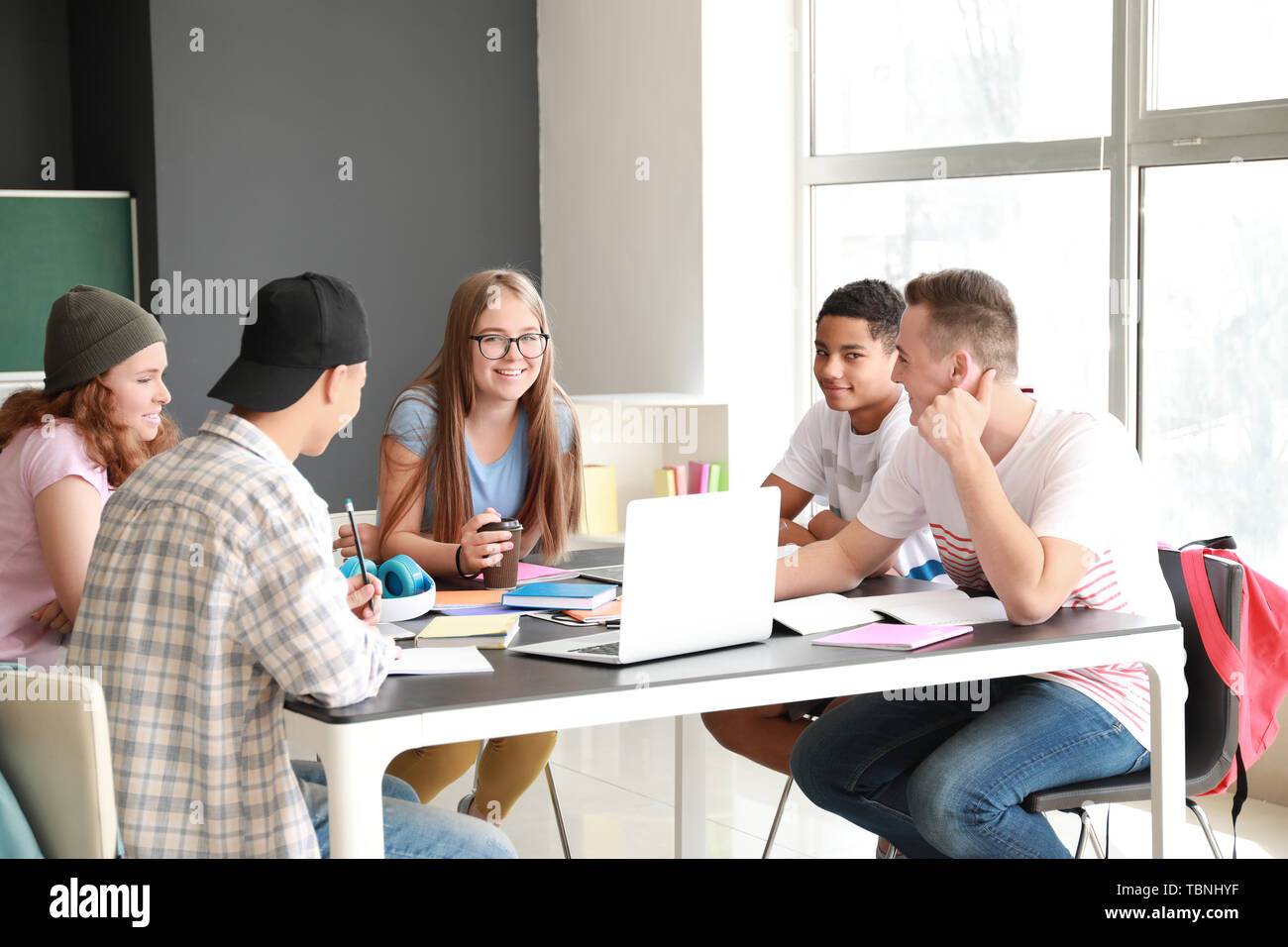 Group of teenagers studying together in school Stock Photo - Alamy