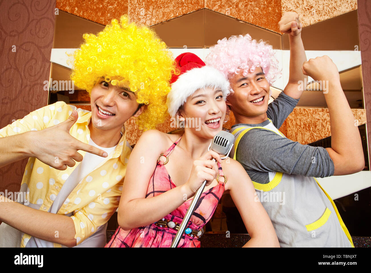 Three friends sing at KTV party Stock Photo - Alamy