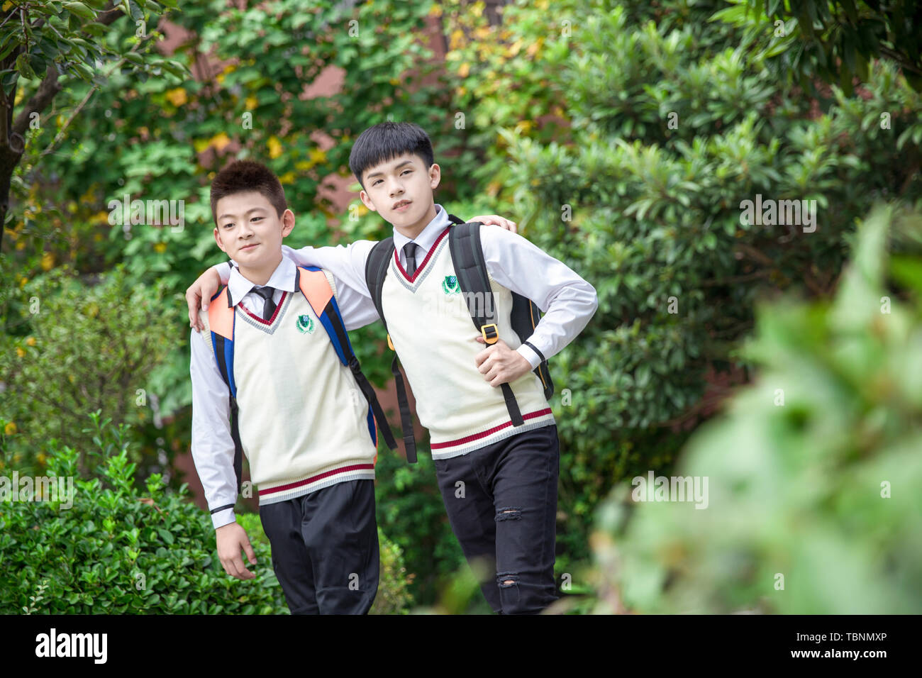 Two boys walking to school hi-res stock photography and images - Alamy