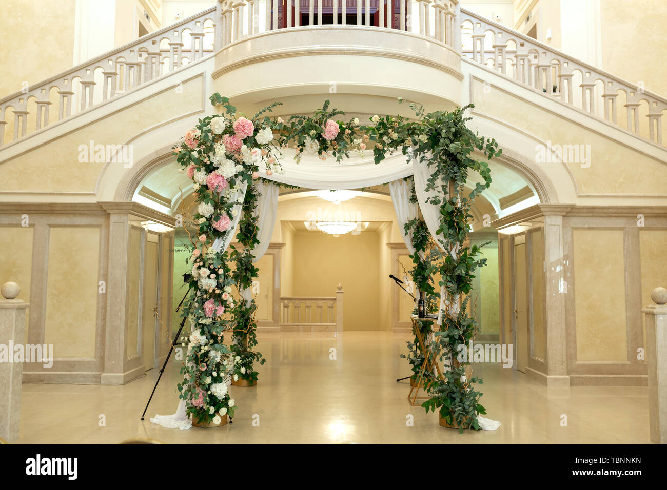 Wedding chuppah decorated with fresh flowers indoor banquet hall of ...