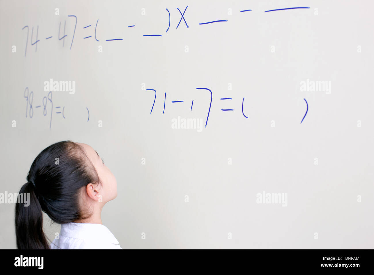 Three primary school students are in class in the classroom Stock Photo ...