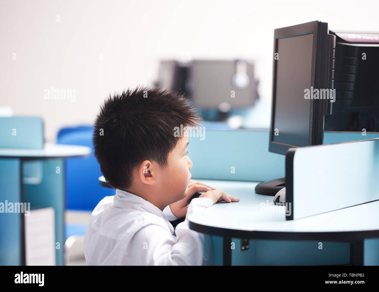 Three primary school students are in class in the classroom Stock Photo ...