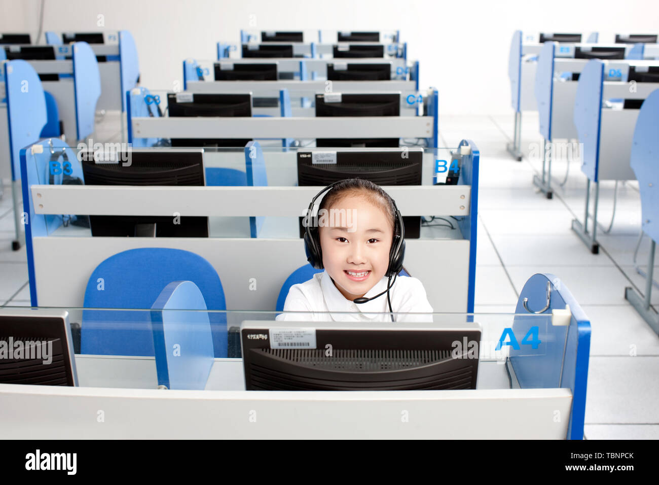 Three primary school students are in class in the classroom Stock Photo ...
