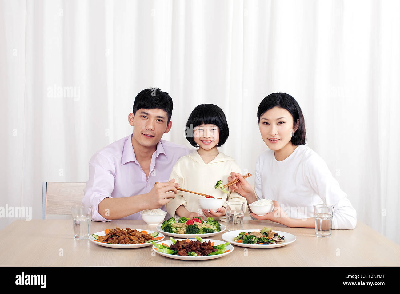Parents celebrate daughter's birthday Stock Photo - Alamy