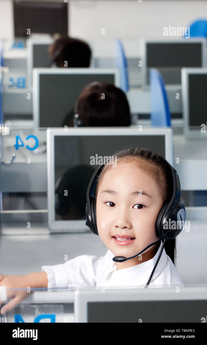 Three primary school students are in class in the classroom Stock Photo ...
