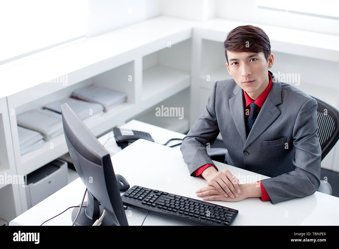A white-collar worker is busy at work in the office Stock Photo - Alamy