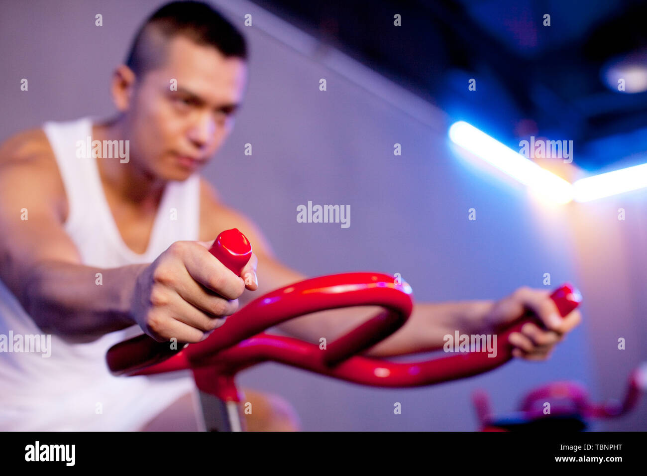 Riding a gym bike at the gym Stock Photo - Alamy