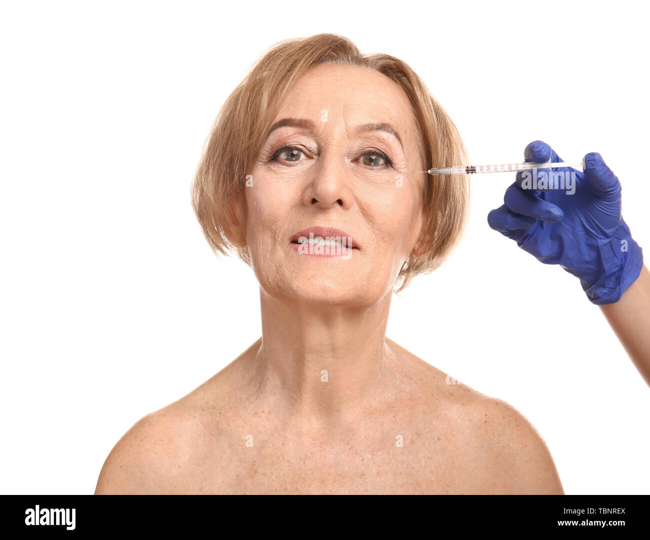 Beautiful mature woman receiving injection against white background ...