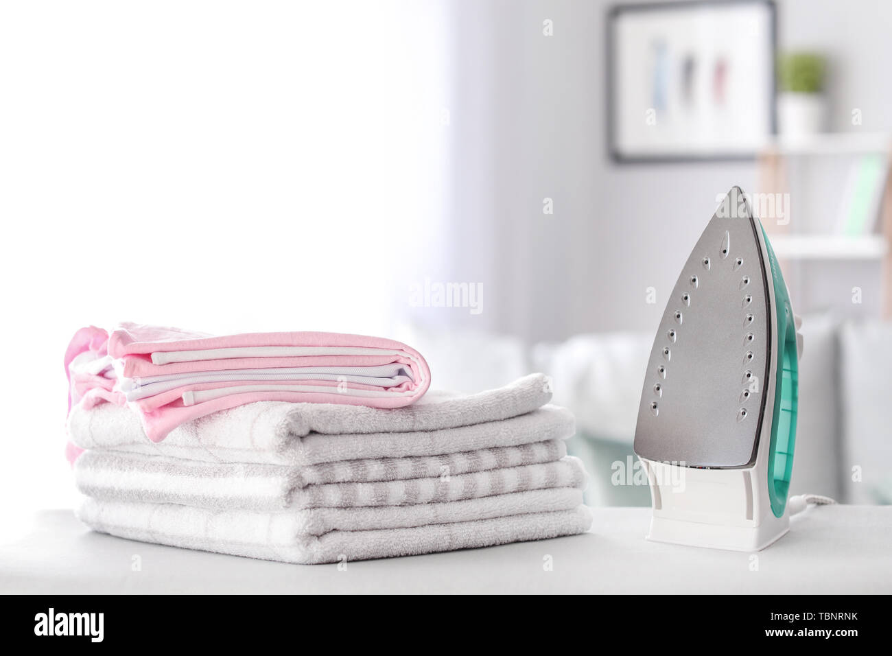 Iron and clean clothes on board Stock Photo - Alamy