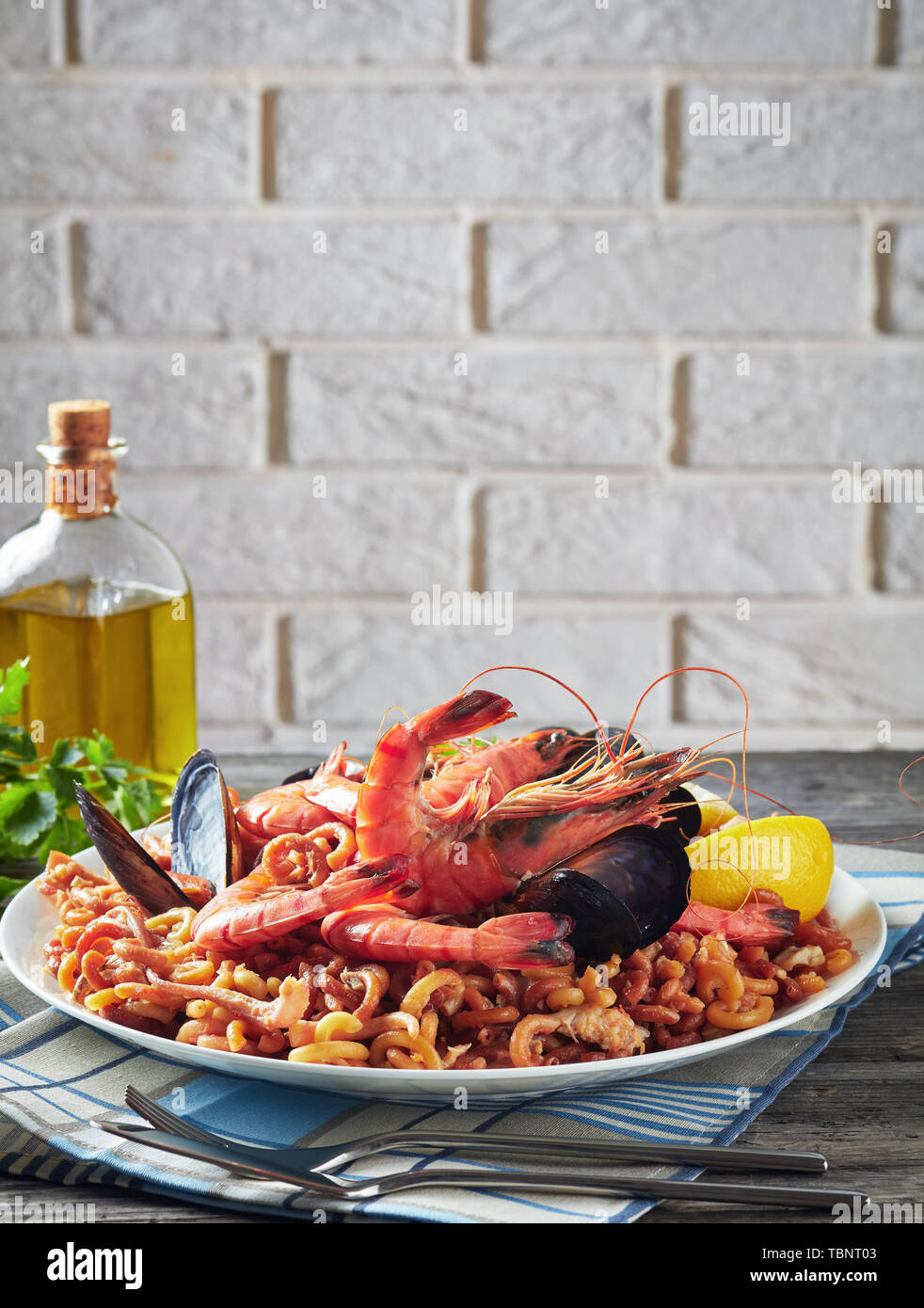 Spanish Fideua, a noodle Paella with prawns, fish, calamari, mussels ...
