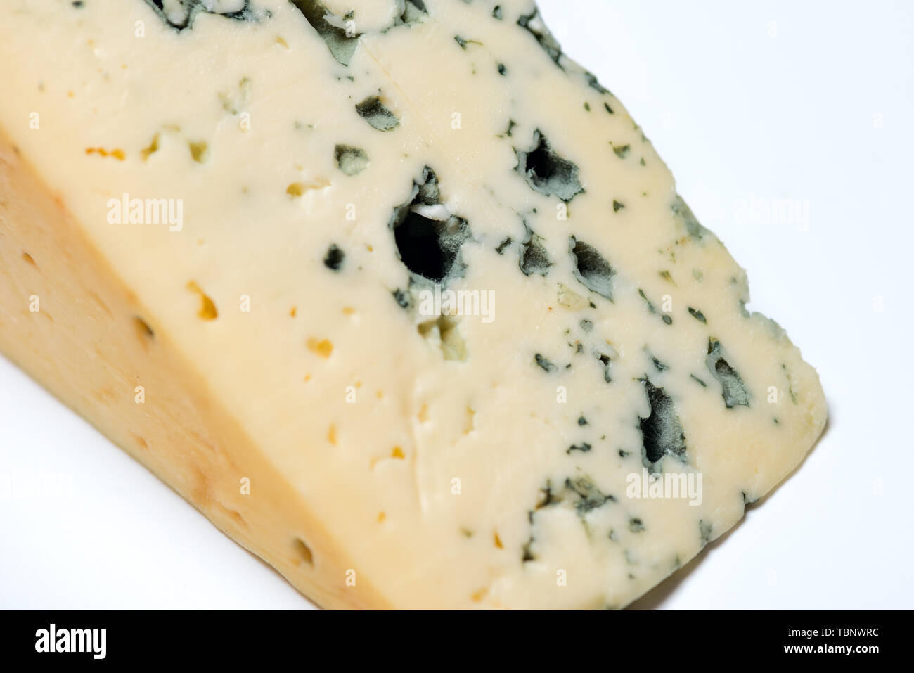 big piece of cheese with mold close up on white background Stock Photo ...