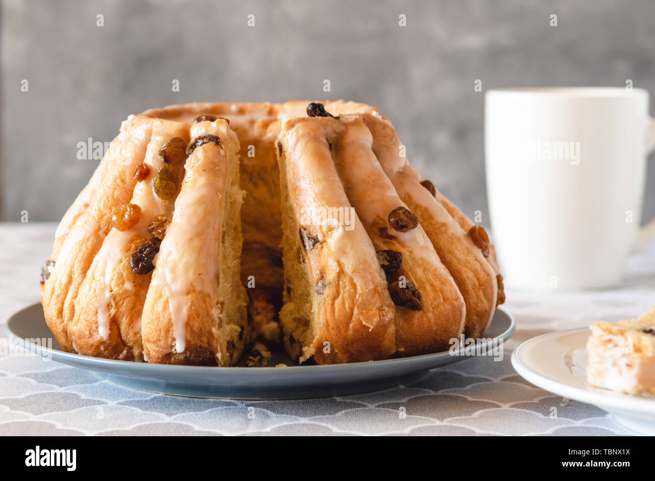 Traditional yeast ring cake with icing and raisins Stock Photo - Alamy