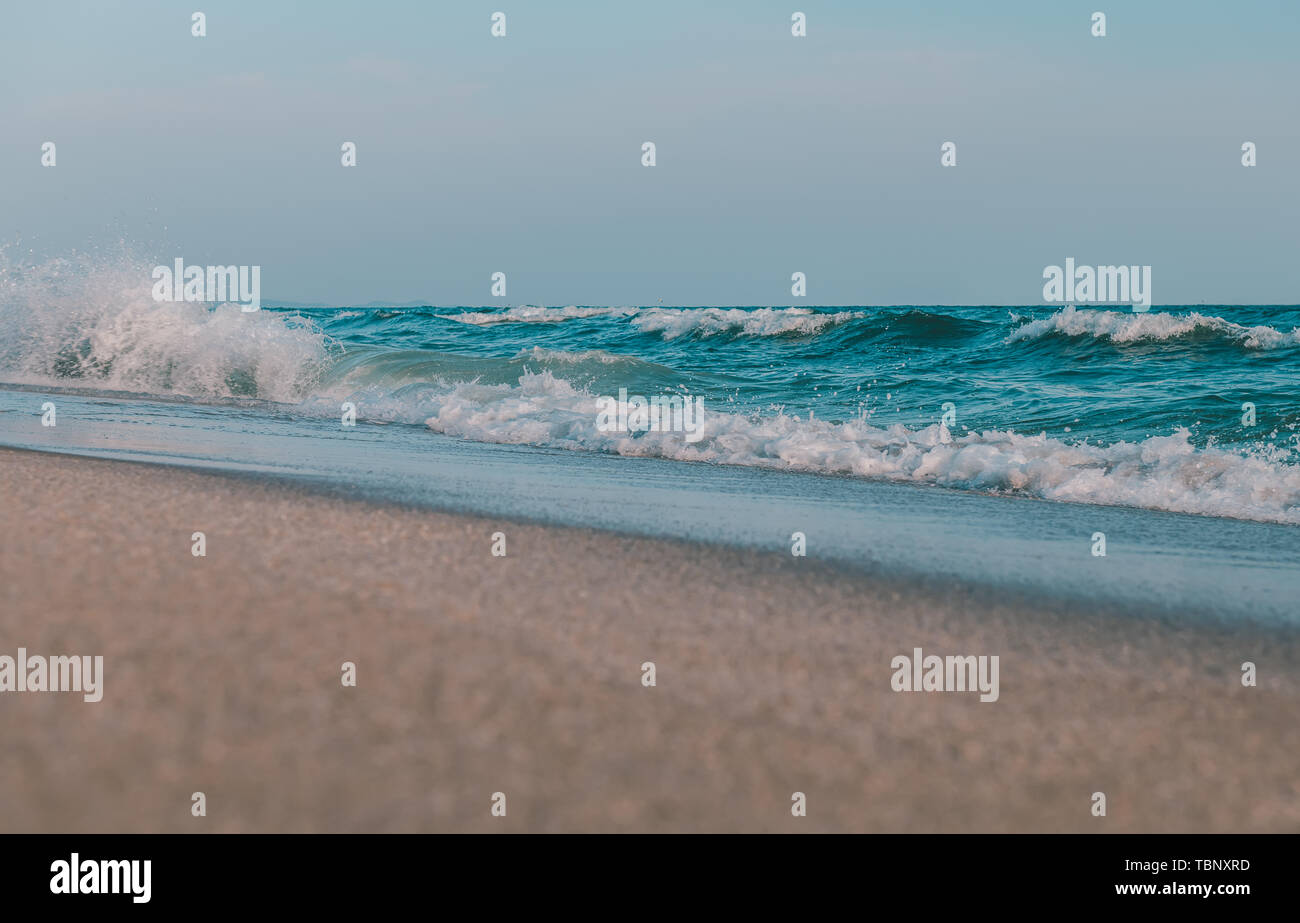 Sea wave and brown sand beach applied with deep gray warm tone color ...