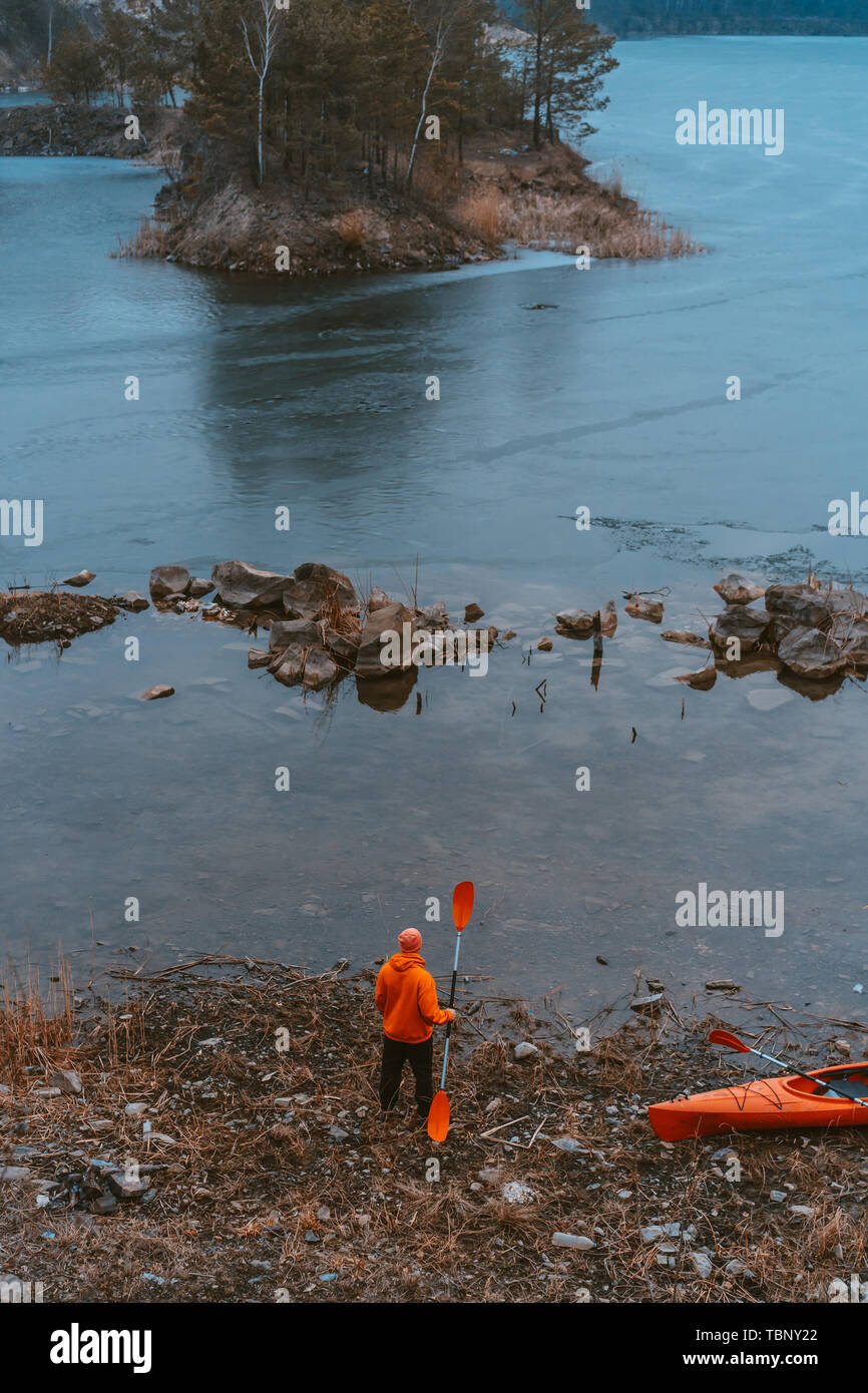 The guy is standing at the frozen lake Stock Photo - Alamy