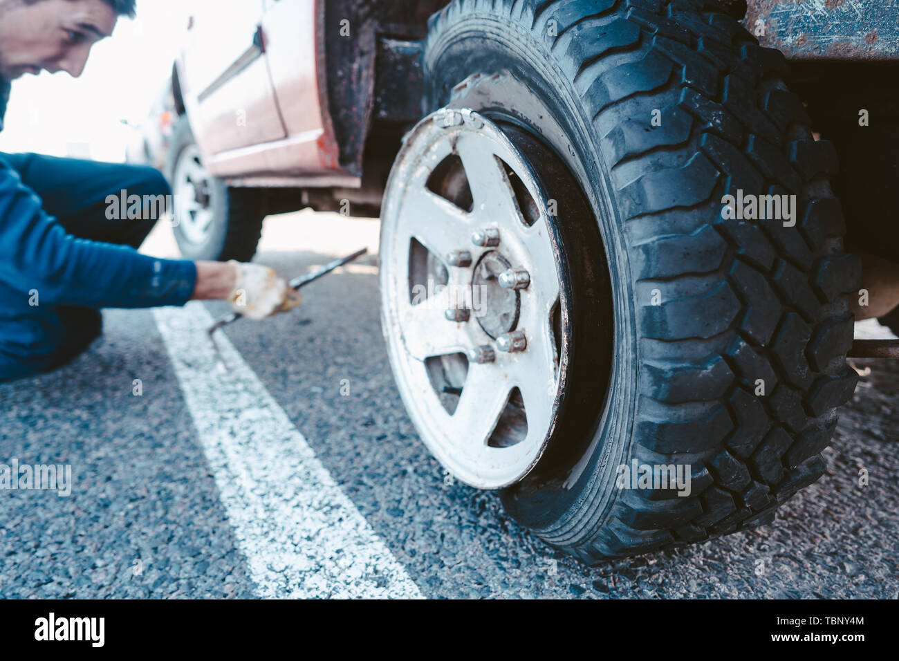 Man change the wheel manually on a 4x4 off road truck Stock Photo - Alamy