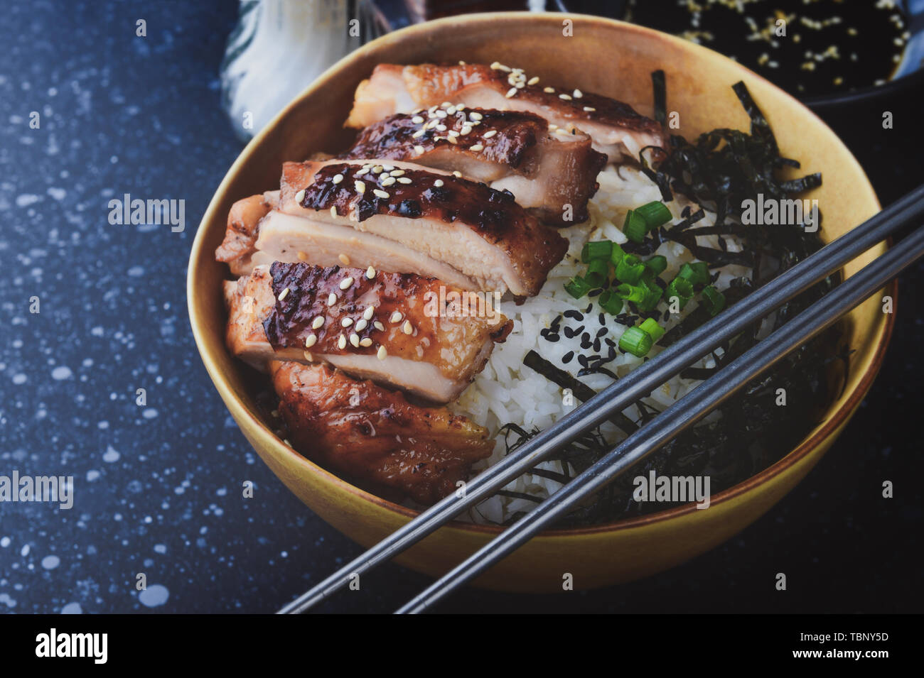 Rice cup with grilled chicken in Japanese style or yakitori don applied ...