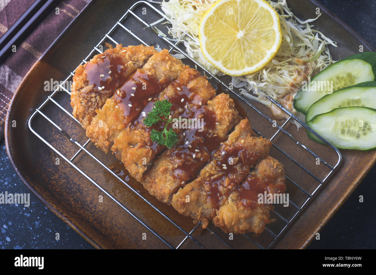 Deep fried pork in Japanese style name tonkatsu set in grey tone color ...