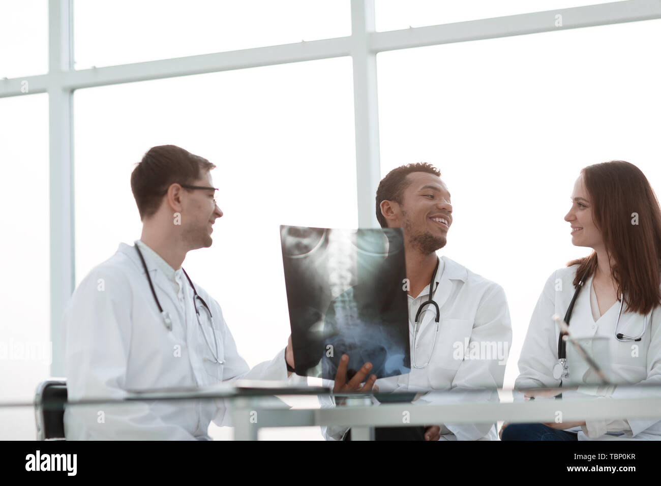 smiling group of doctors discussing the patient's x-ray . the concept ...