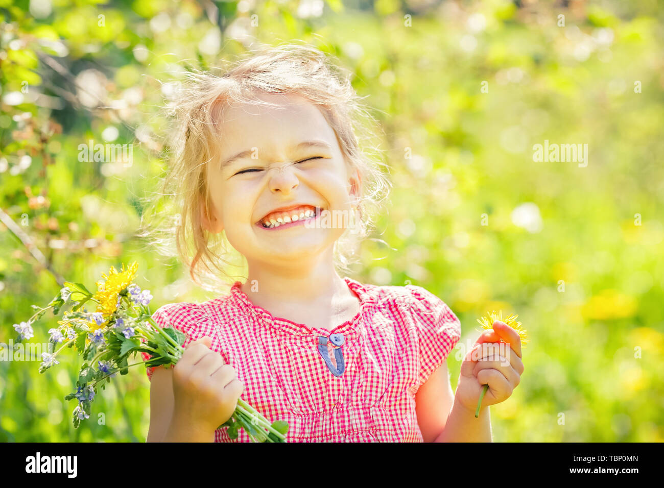 Happy little girl in spring sunny park Stock Photo - Alamy
