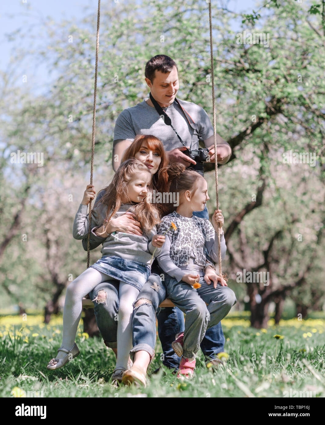 Happy family resting in the spring garden. the concept of parenting ...