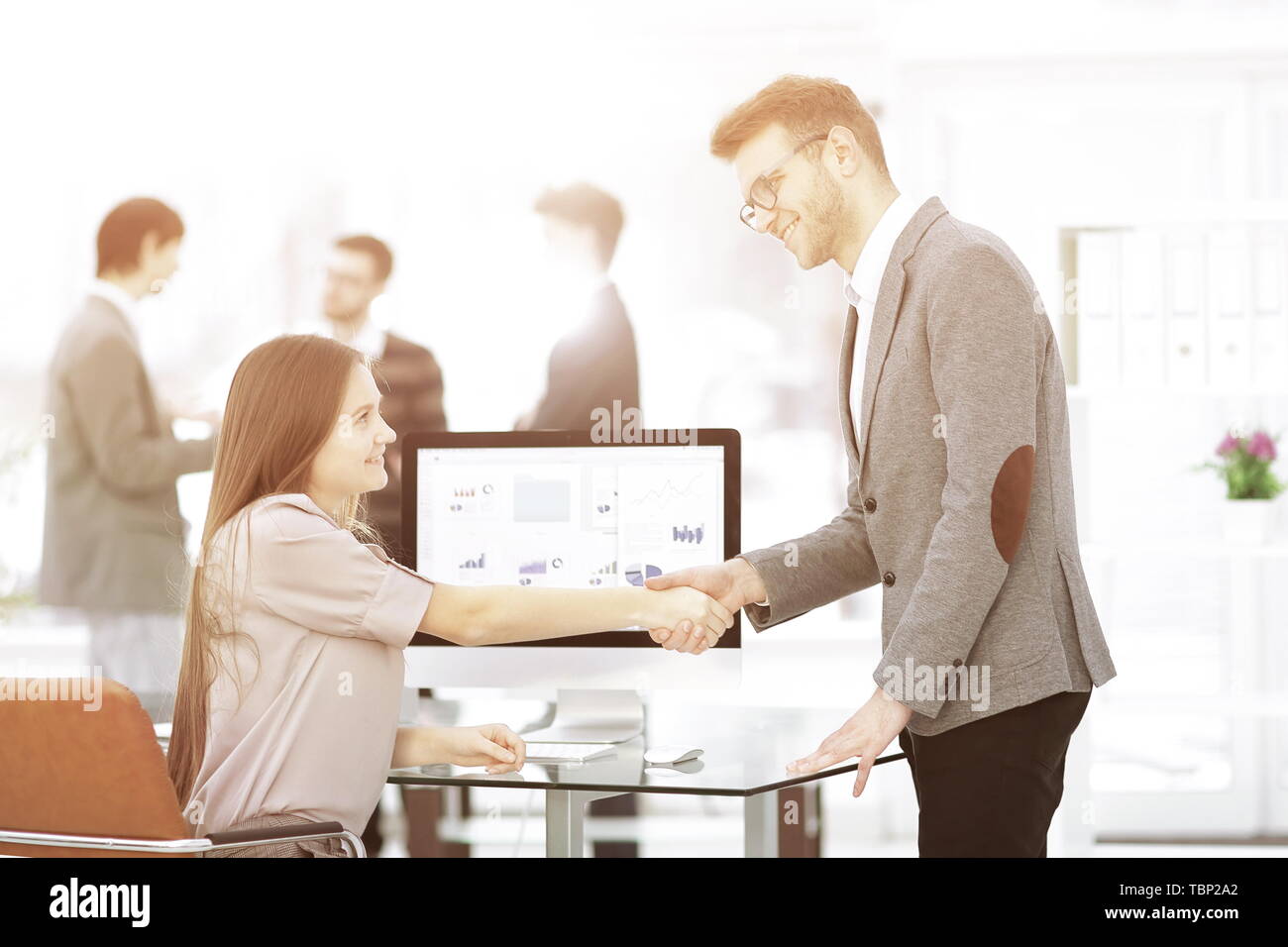 Manager and employee shaking hands to each other as a sign of success ...