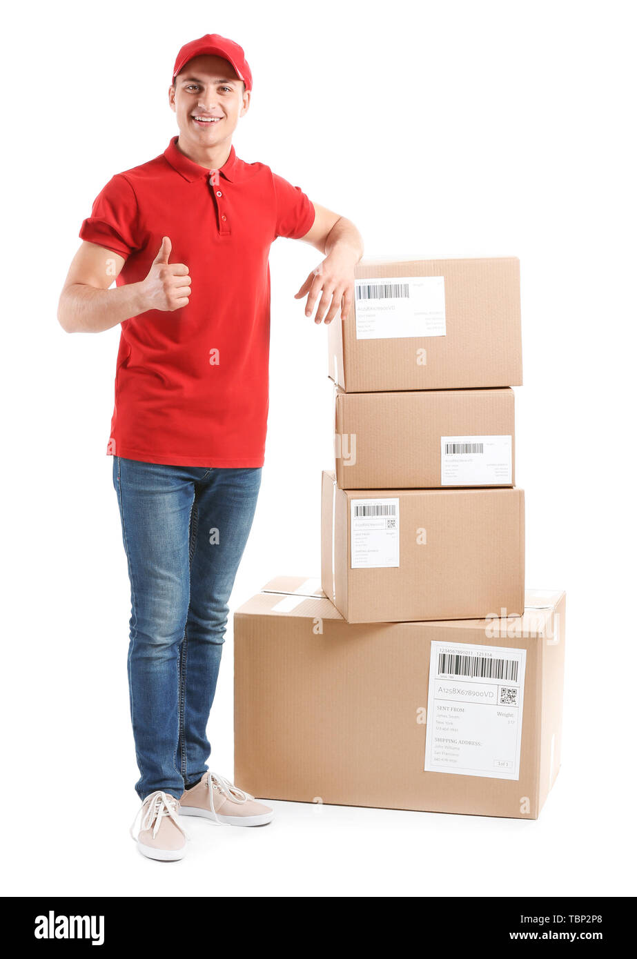 Delivery man with boxes showing thumb-up on white background Stock ...