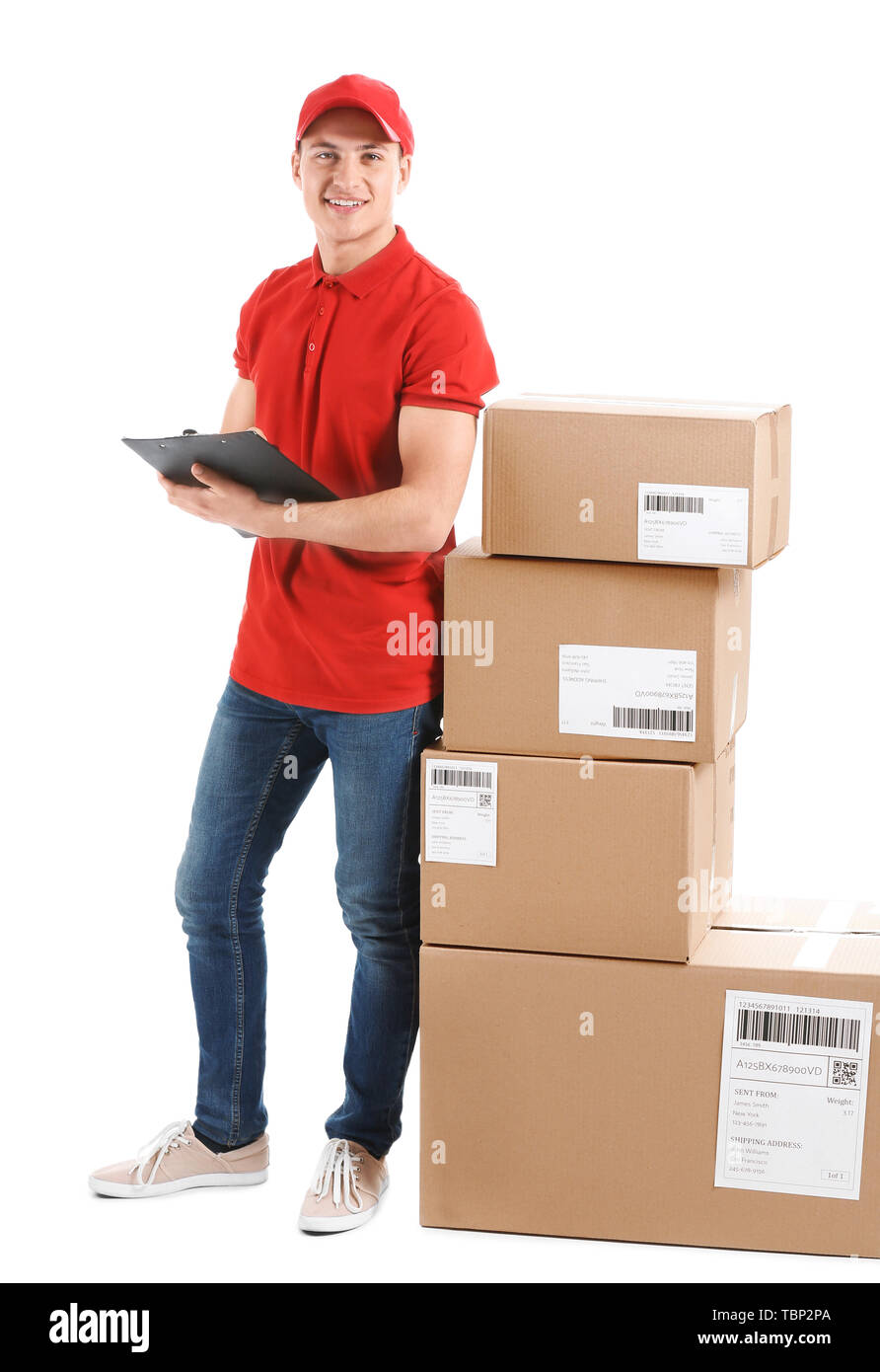 Delivery man with boxes and clipboard on white background Stock Photo ...
